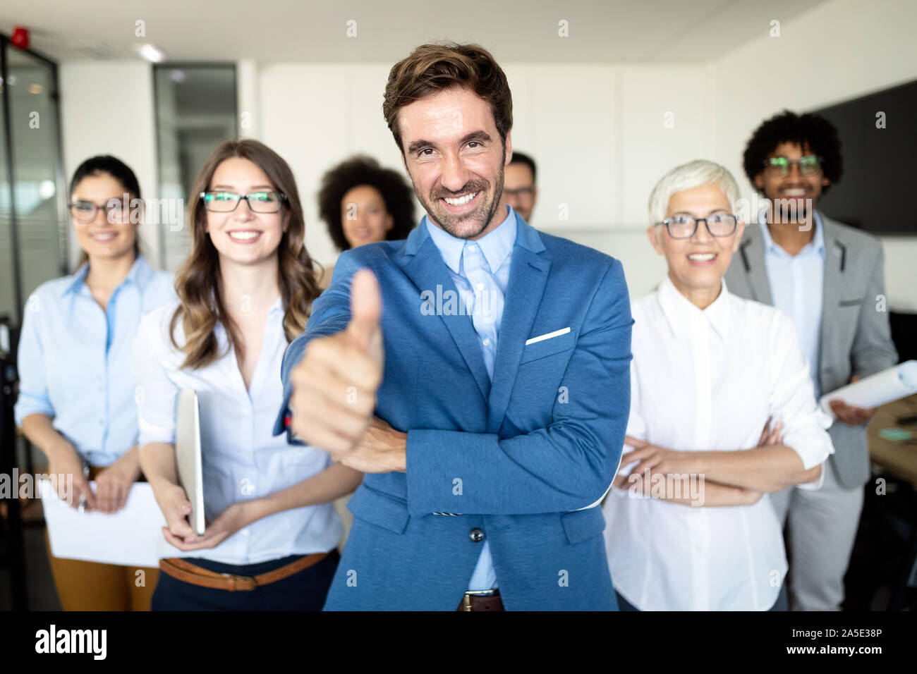 Happy business people celebrating success at company Stock Photo - Alamy