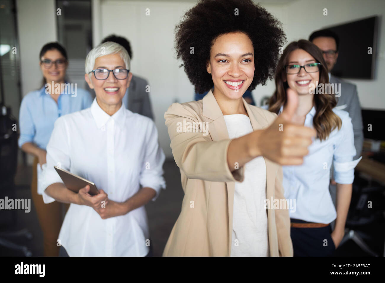 Happy business people celebrating success at company Stock Photo - Alamy