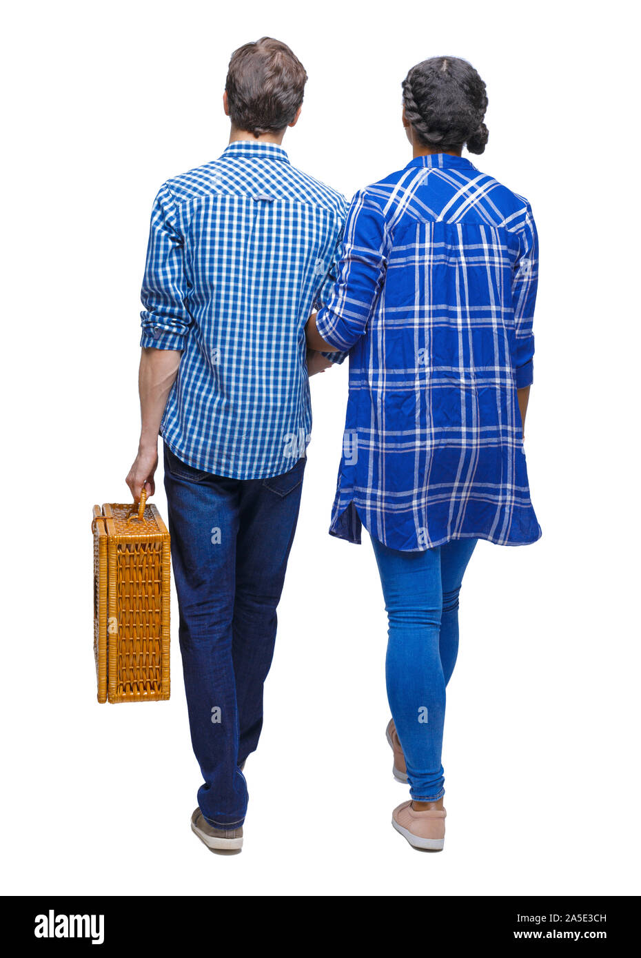 Back view of interracial going couple with a picnic bag. walking ...