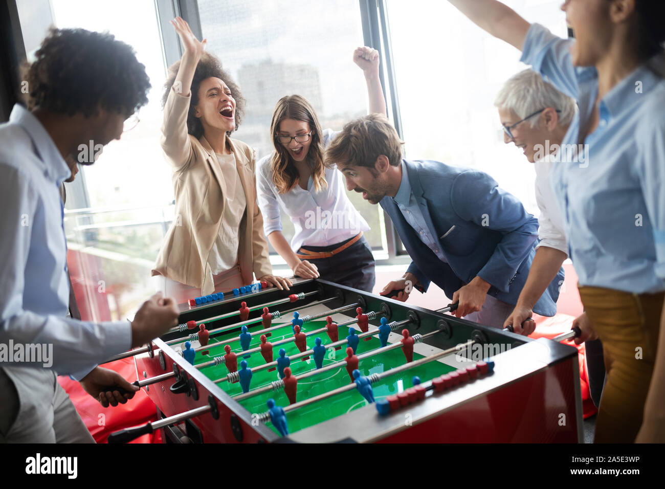 Multicultural friends playing soccer hi-res stock photography and ...