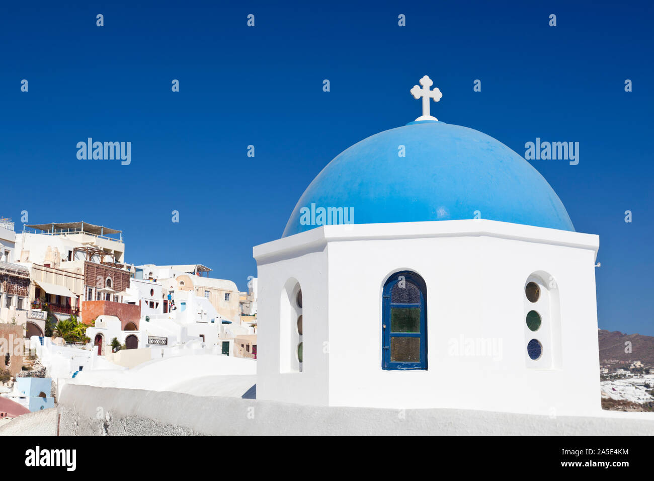 One of the famous churches with blue domes in Oia with deep blue sky ...