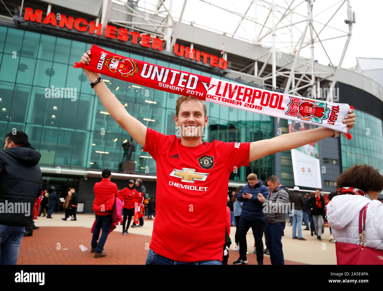 A Manchester United fan poses for a photo outside the stadium before ...