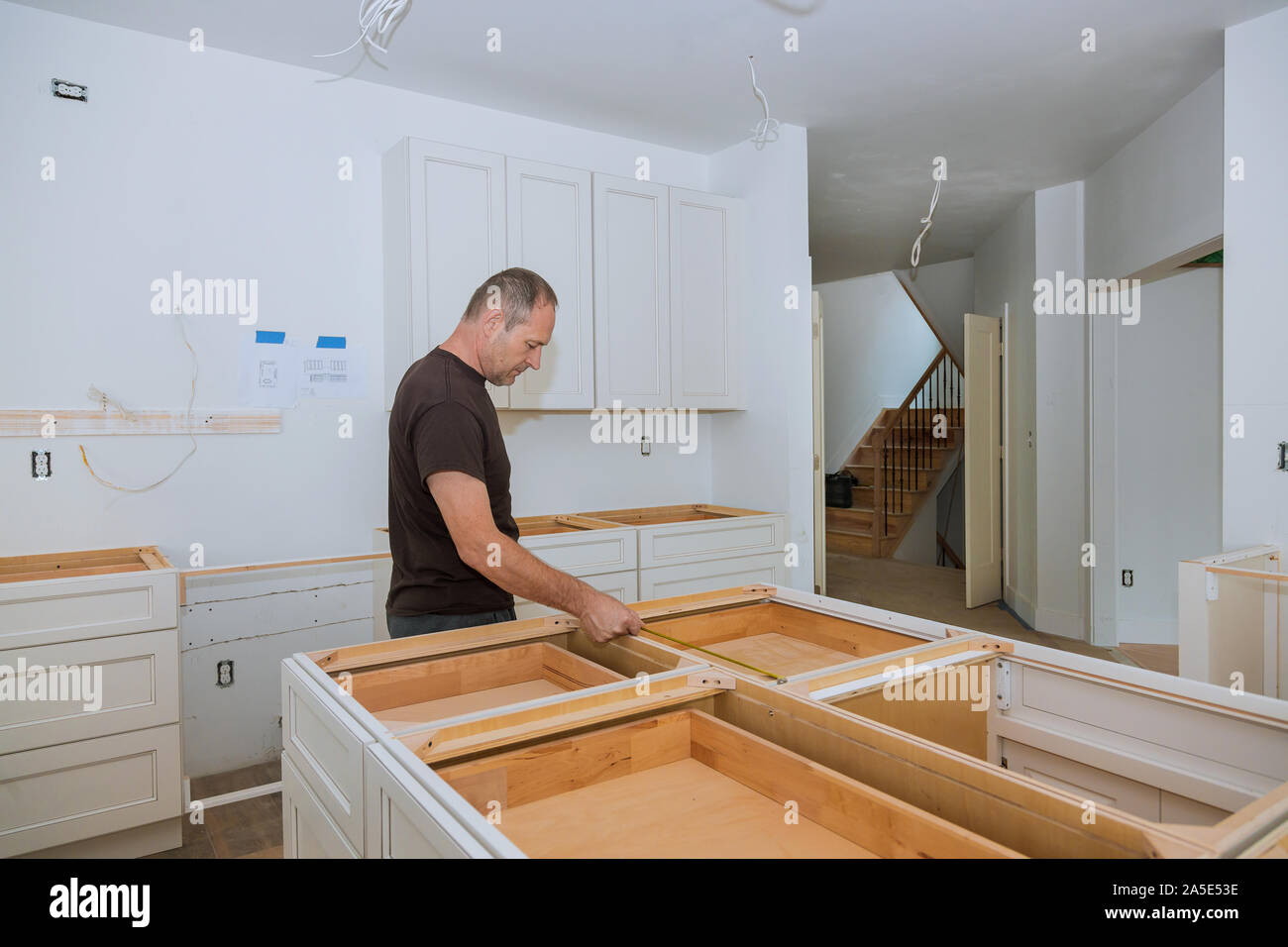 Man using tape to measure cabinet hi-res stock photography and images ...
