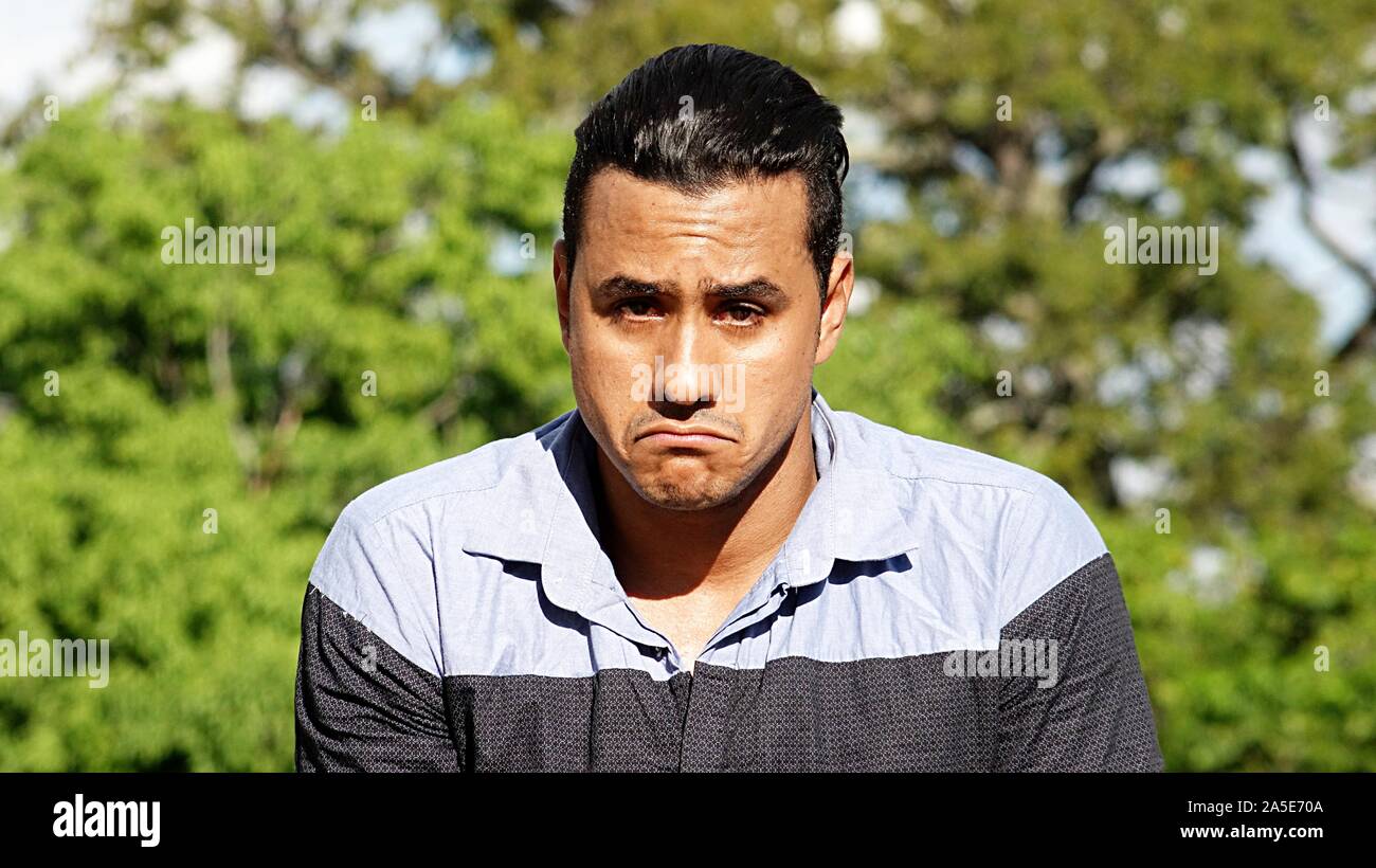 An Unhappy Adult Hispanic Male Stock Photo - Alamy