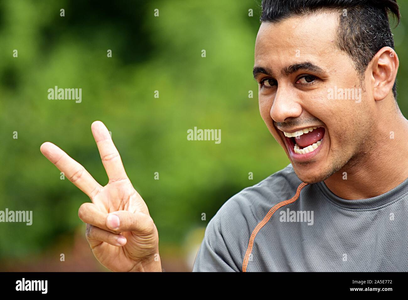 An Athletic Man And Peace Sign Stock Photo - Alamy