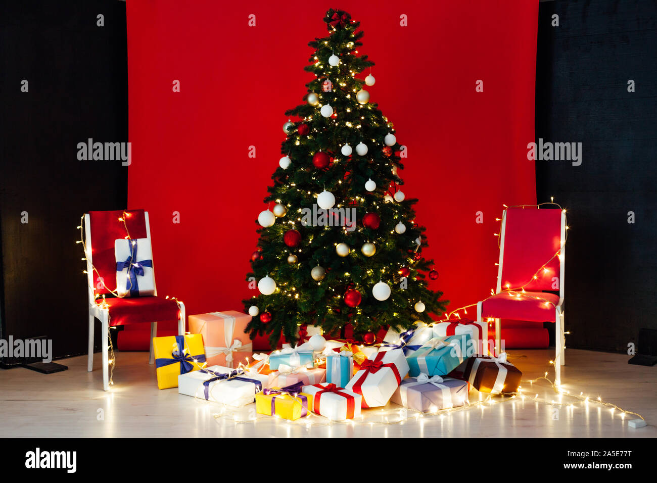 Christmas lights in the red room of new year Christmas tree gifts Stock ...