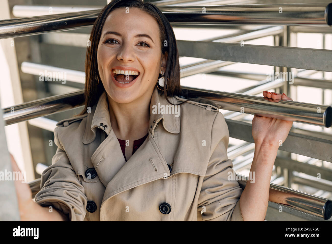 Beautiful female person keeping smile on face while posing on camera ...