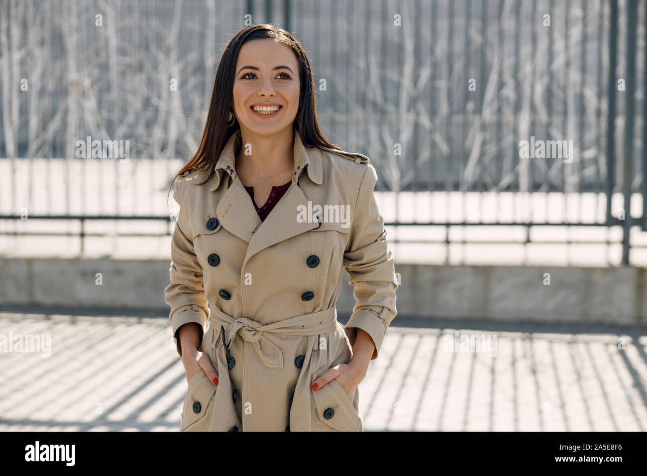 Cute female demonstrating her smile, keeping hands in the pockets Stock ...