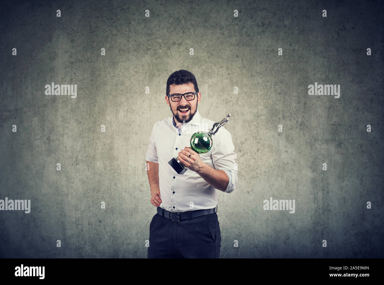 excited business man winning a trophy Stock Photo - Alamy