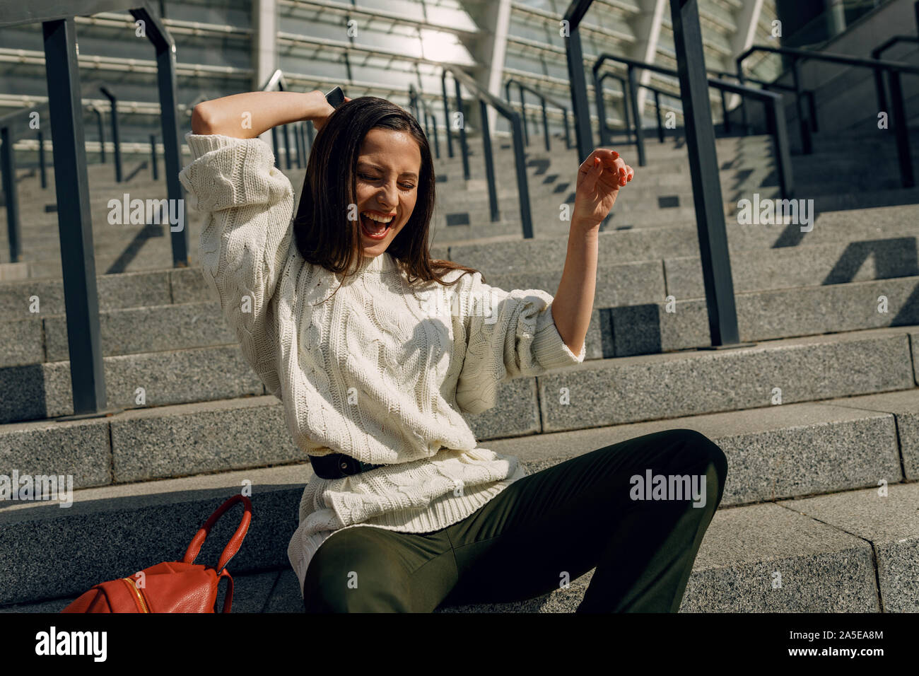 Be happy. Cheerful girl keeping smile on her face while having rest ...