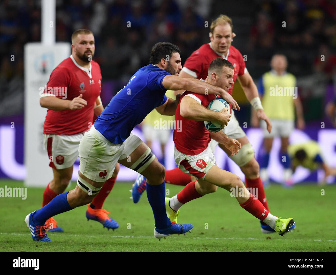 Wales' Gareth Davies is tackled by France's Charles Ollivon during the ...