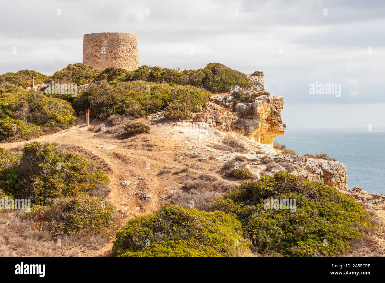 round watchtower on the cliffs above atlantic ocean on the algarve ...
