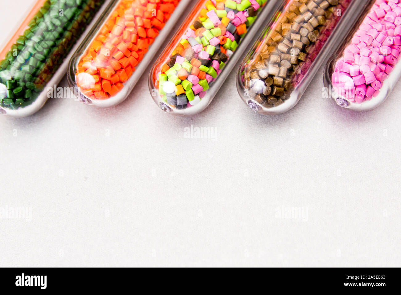 Plastic pellets .Polymeric dye in test tubes on gray background Stock ...