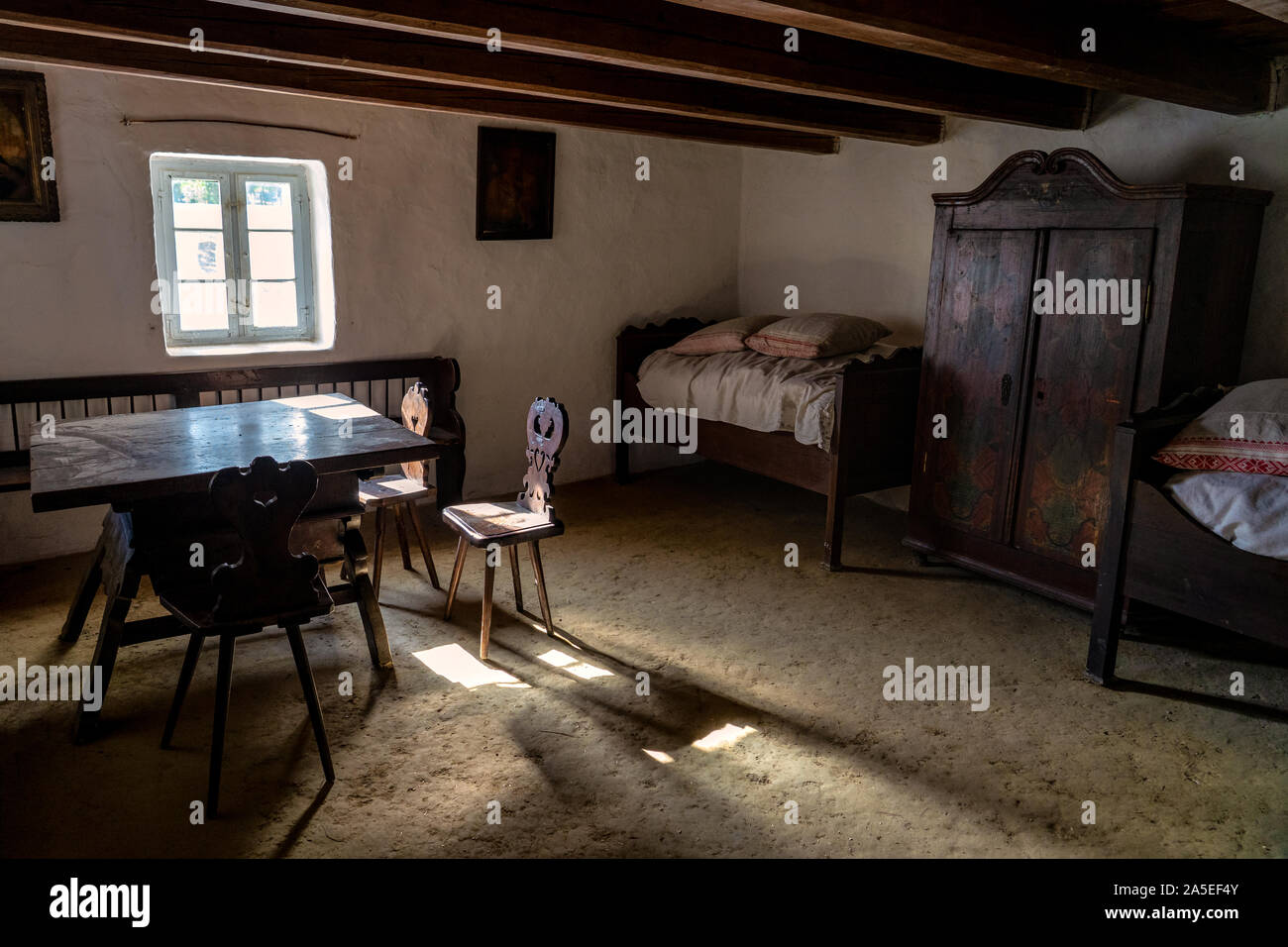 old hungarian village museum tiller house with light from the window ...