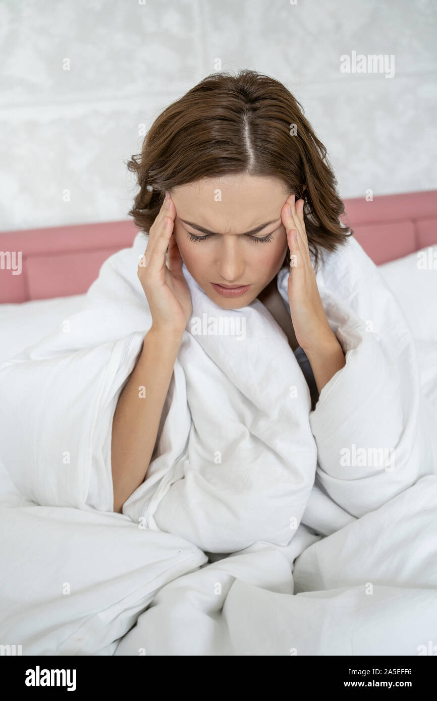 Sad young Caucasian woman suffering from common cold and headache Stock ...