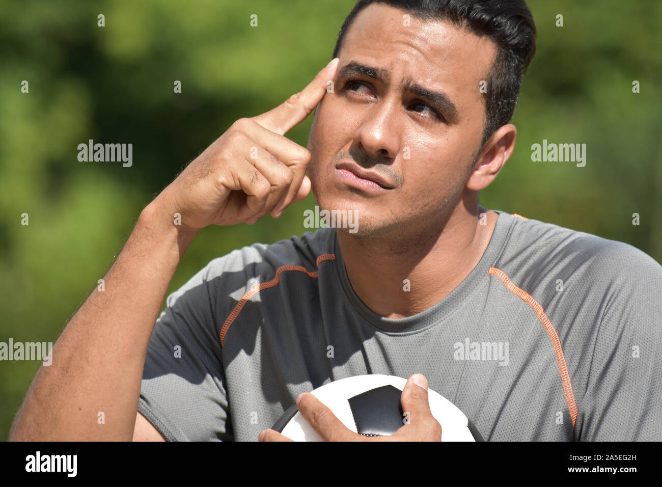 Thinking Adult Male Soccer Player Stock Photo - Alamy