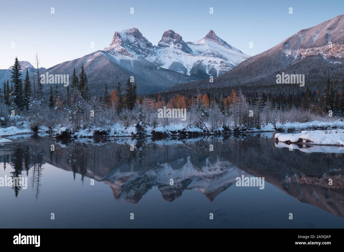 Sunrise of the Three Sisters and the Bow River from Canmore near Banff National Park. First snow ...
