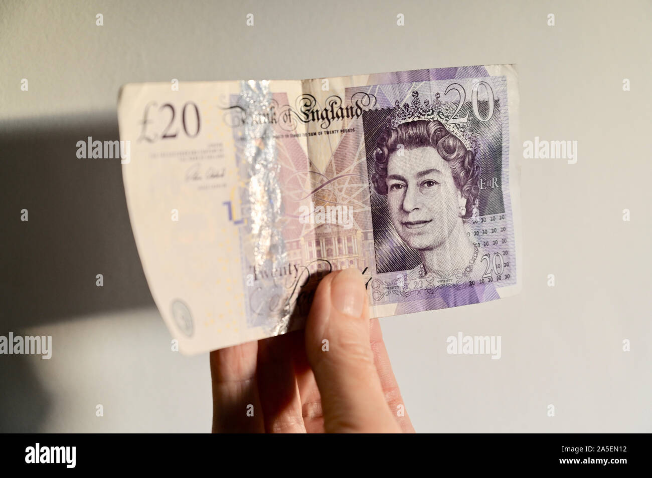 Woman holding pounds hi-res stock photography and images - Alamy