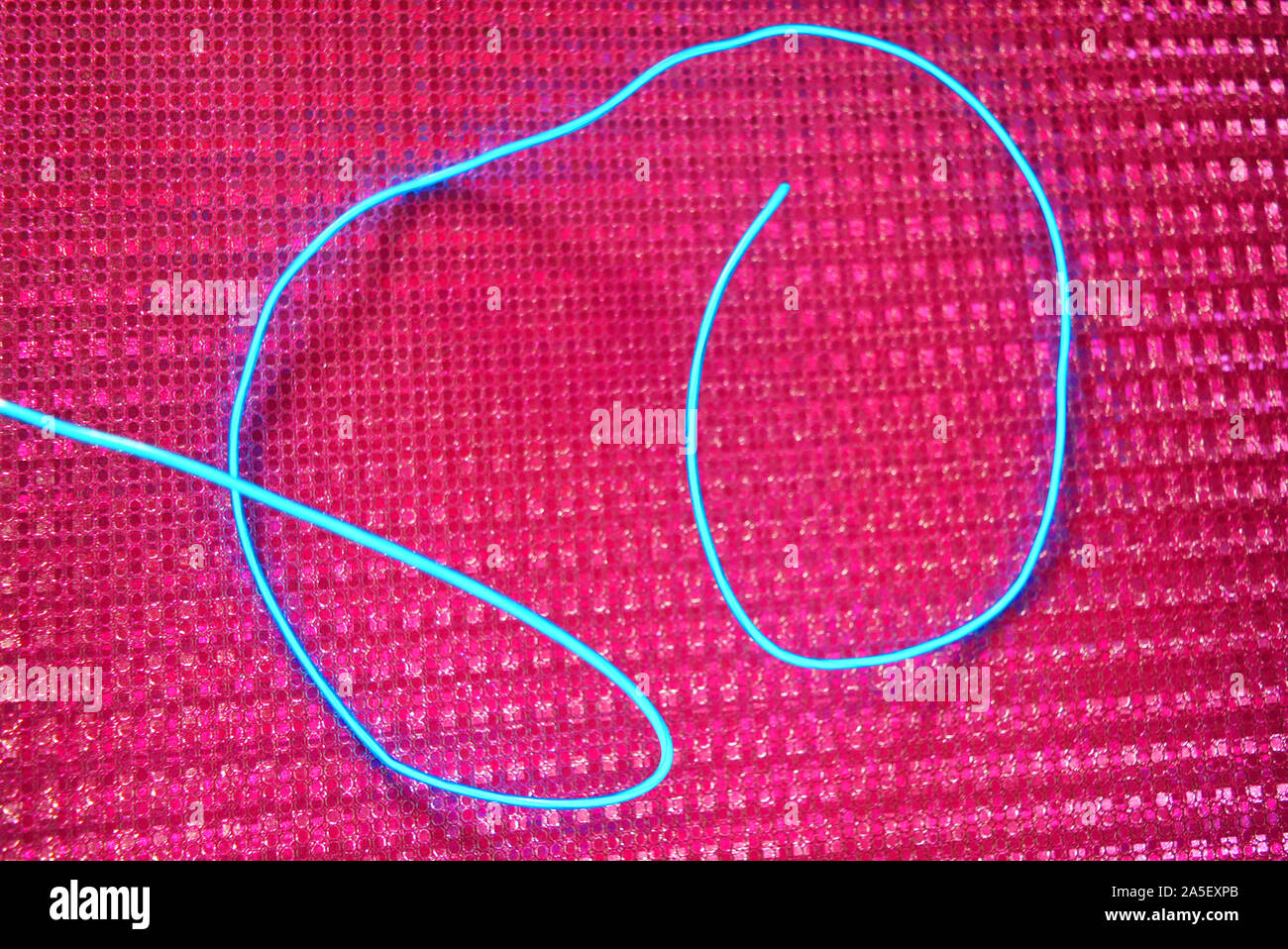 Blue glowing wire, cold neon, electroluminescent cord, cable lies on a ...