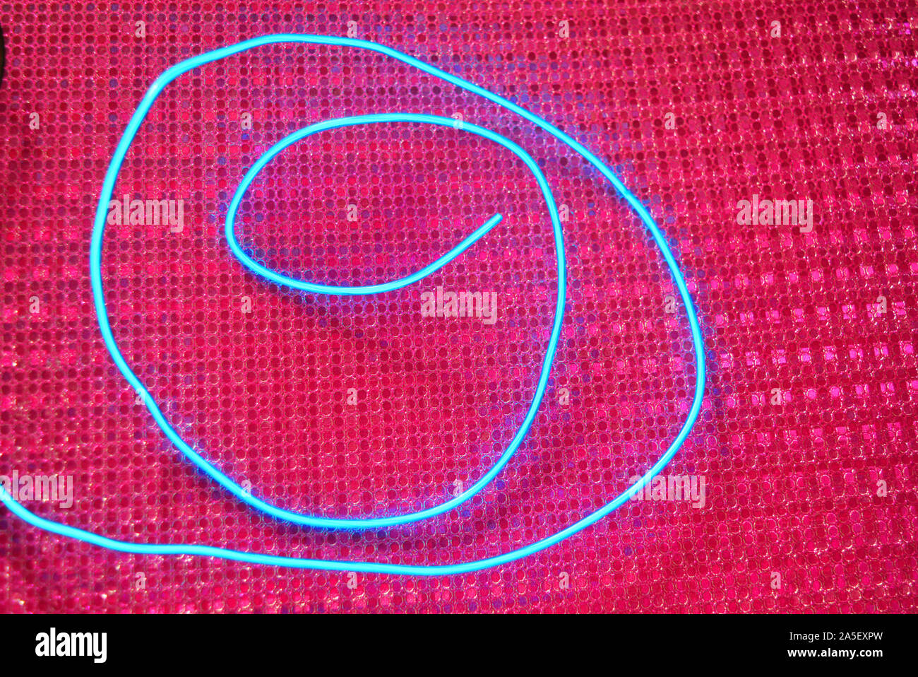 Blue glowing wire, cold neon, electroluminescent cord, cable lies on a ...