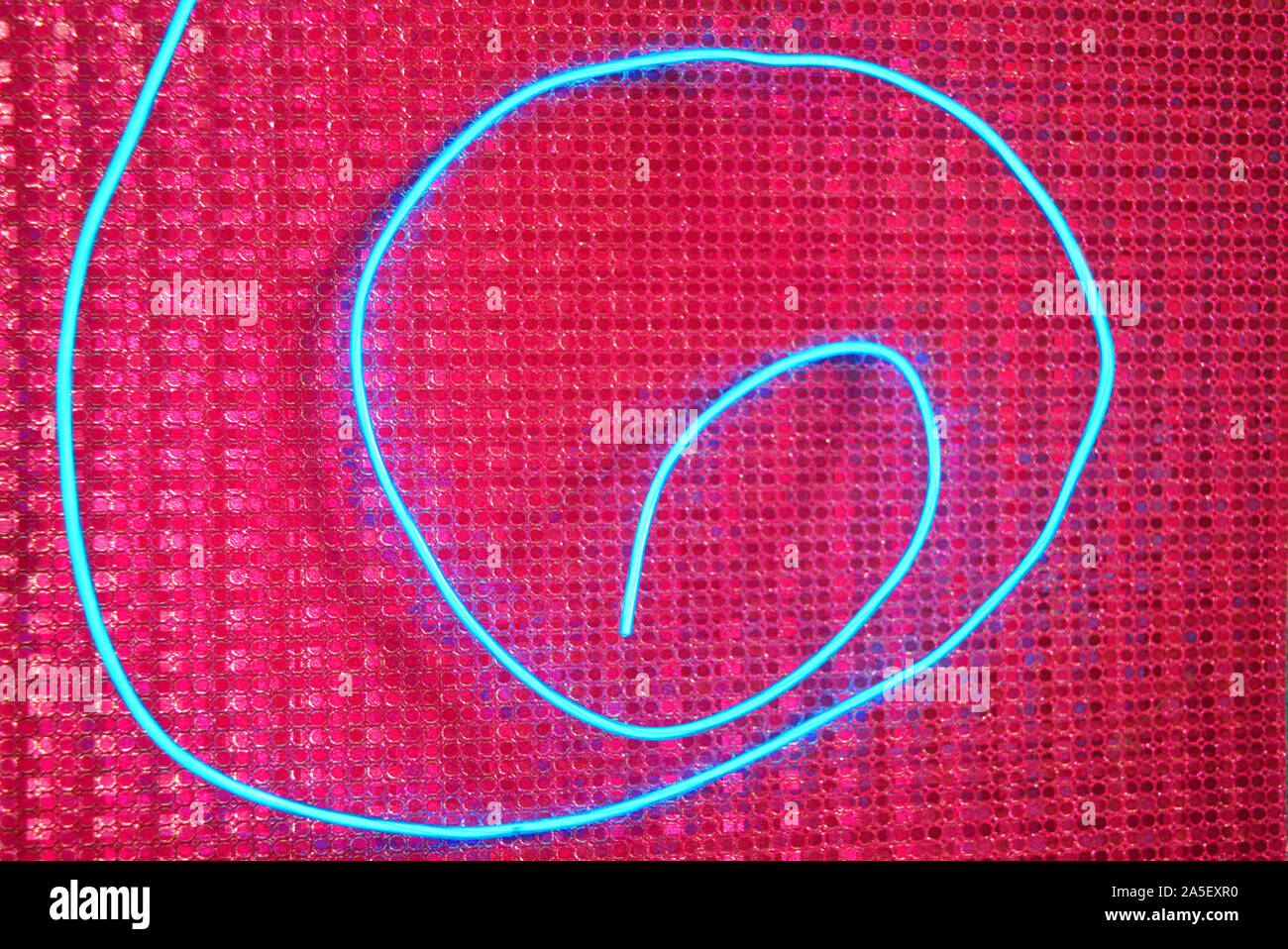 Blue glowing wire, cold neon, electroluminescent cord, cable lies on a ...