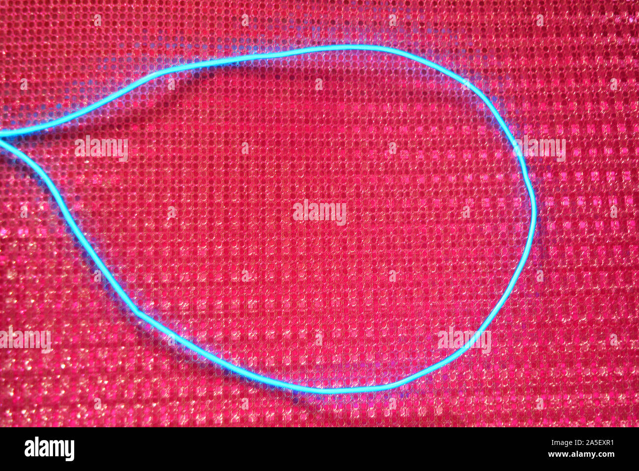 Blue glowing wire, cold neon, electroluminescent cord, cable lies on a ...