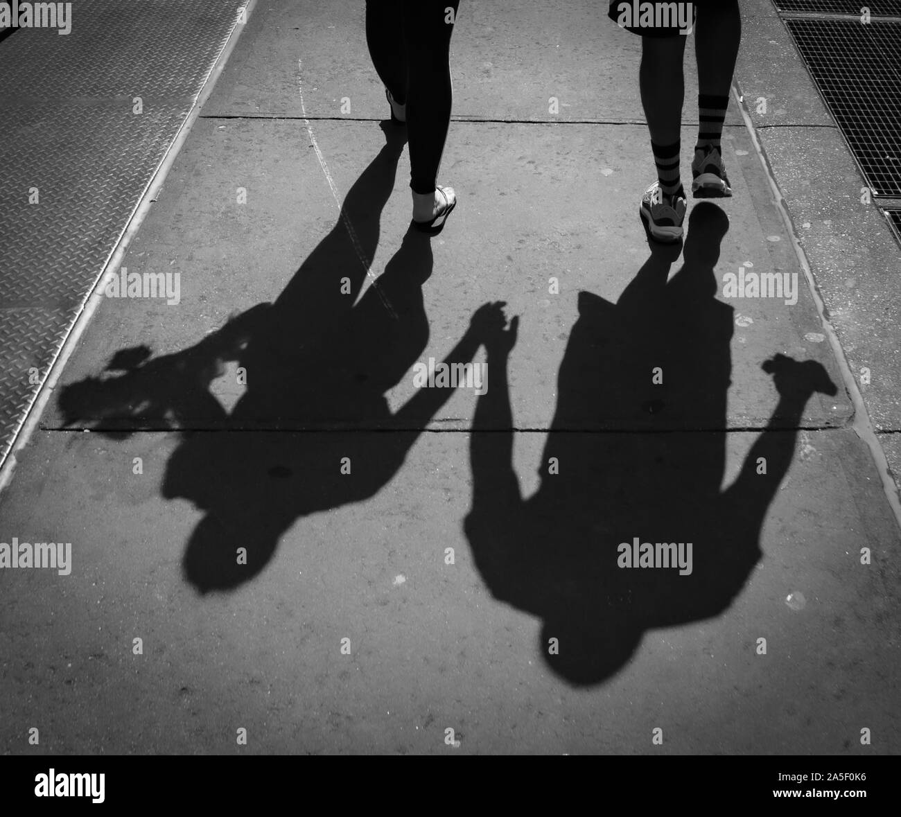 Shadow of couple walking while holding hands Stock Photo - Alamy