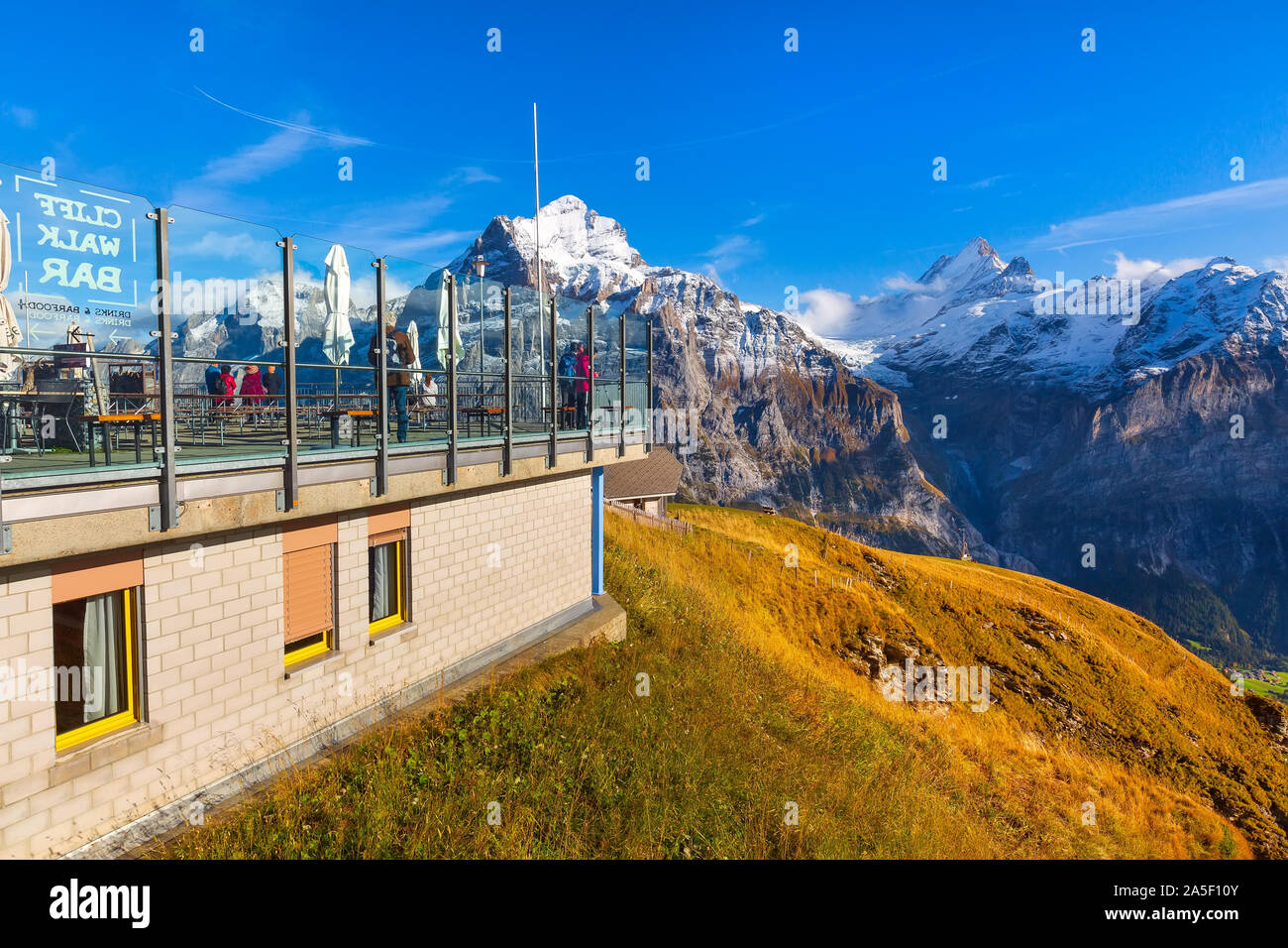 Grindelwald, Switzerland - October 10, 2019: People at the bar terrace ...
