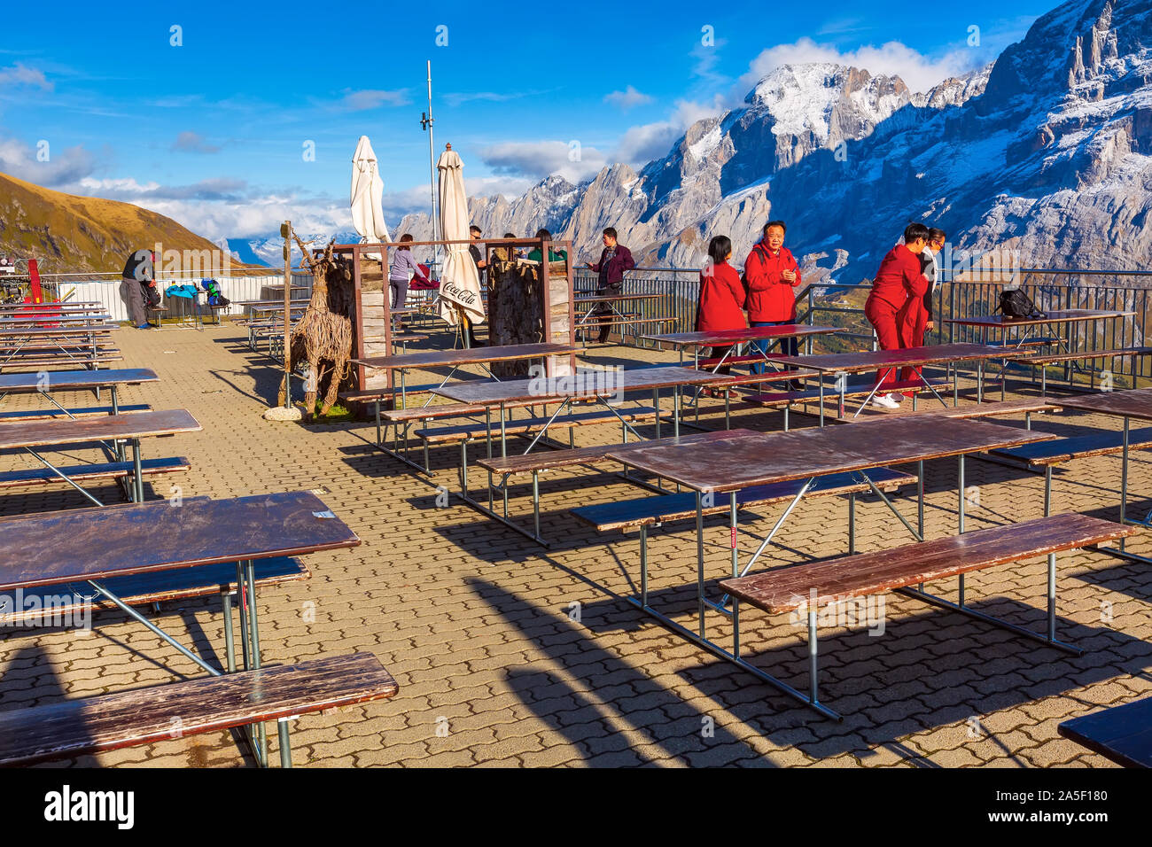 Grindelwald, Switzerland - October 10, 2019: People at the bar terrace ...
