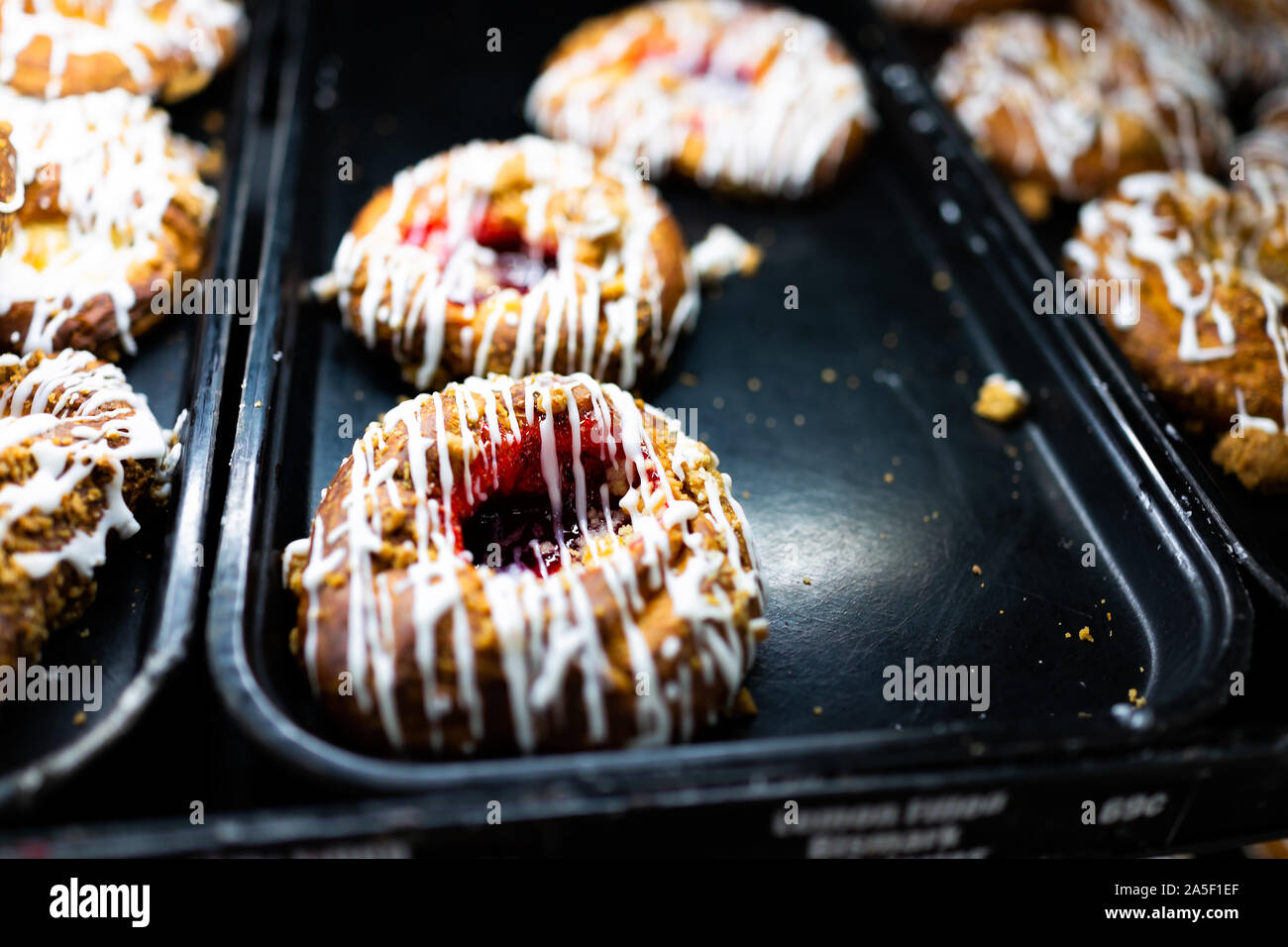 White glaze iced danish pastry fried donuts with red purple raspberry ...