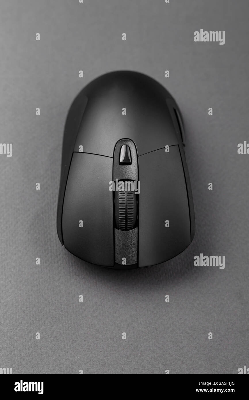 black wireless computer mouse on a black background. modern office ...