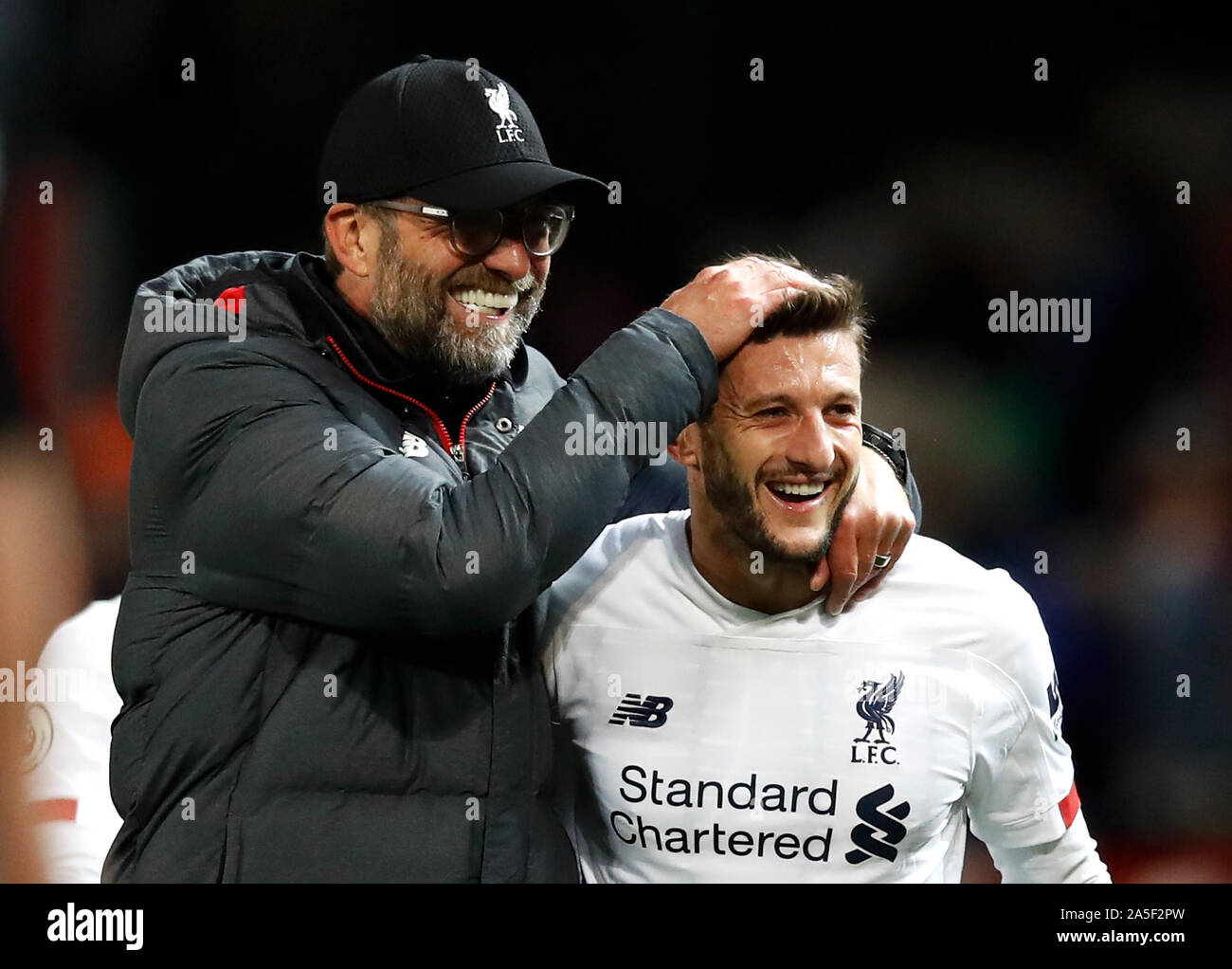 Liverpool manager Jurgen Klopp (left) celebrates with Adam Lallana ...