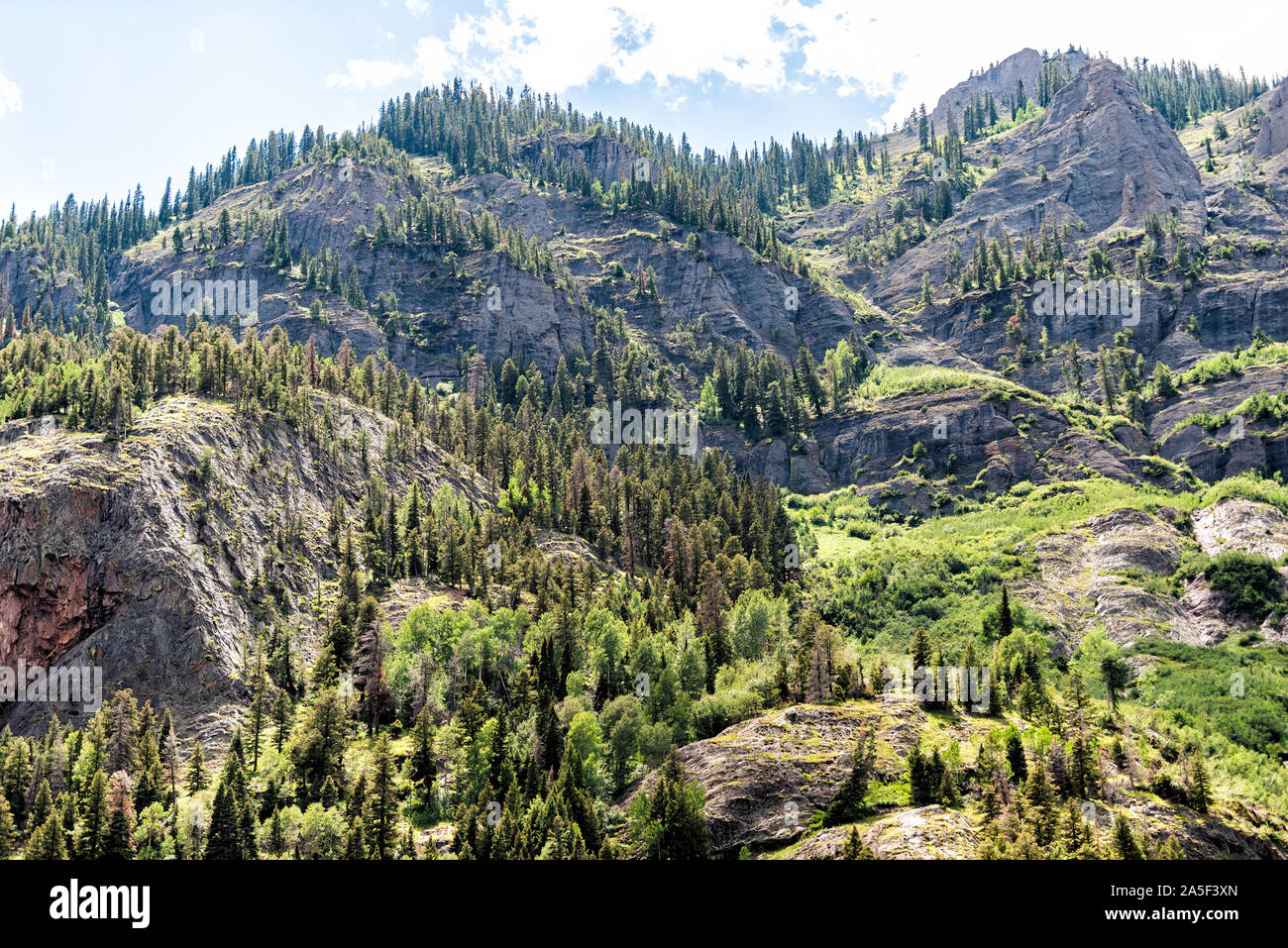 Low angle view of green mountain peak and sky clouds near Ouray ...