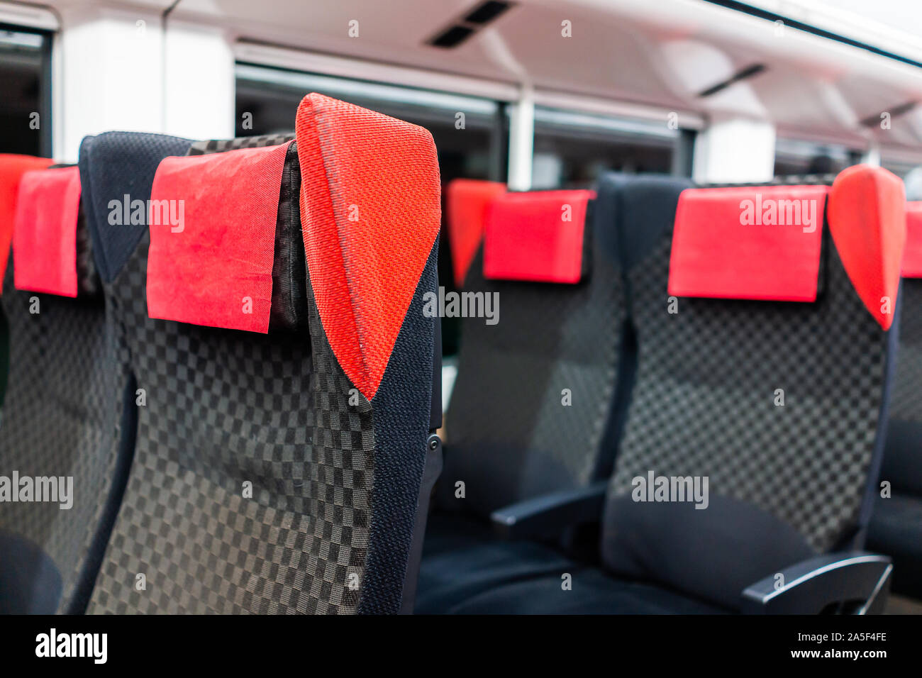Empty red comfortable chairs seats row in aisle in subway train ...