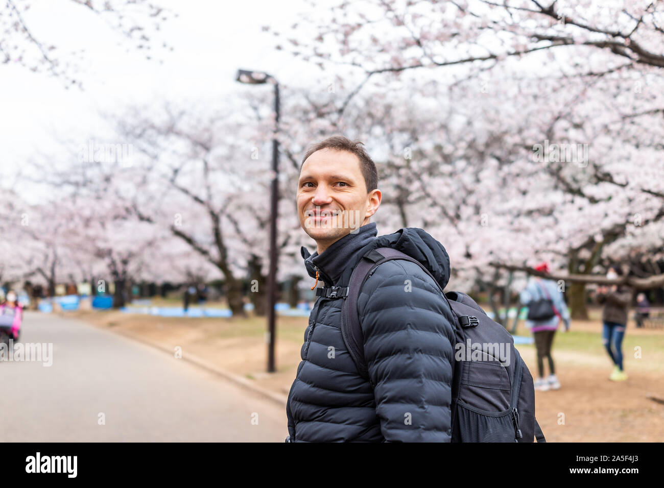Tokyo, Japan Yoyogi park with happy young tourist man walking on road ...