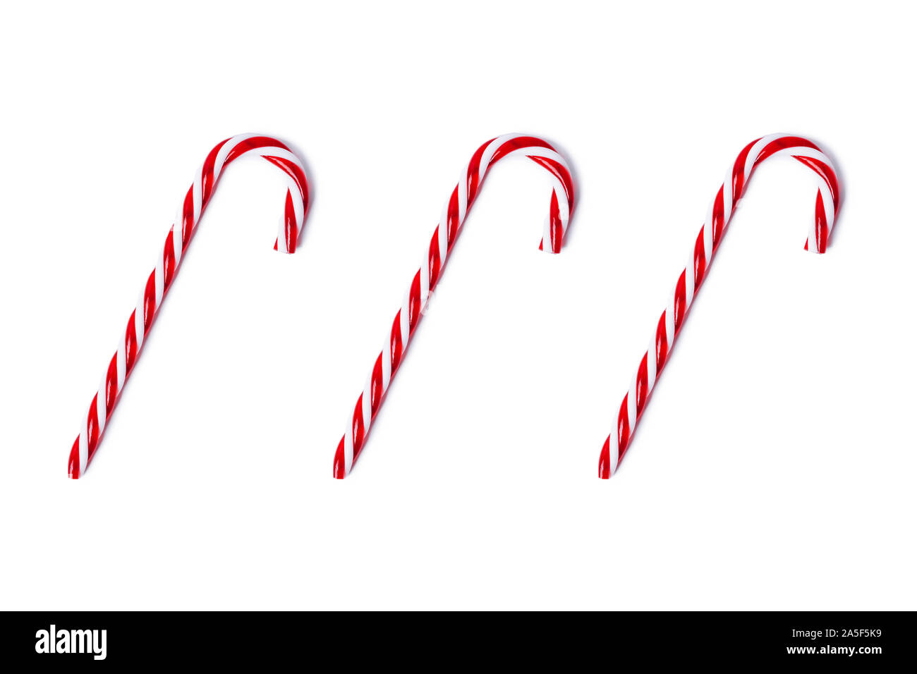 White and red candy canes isolated on white, top view Stock Photo - Alamy