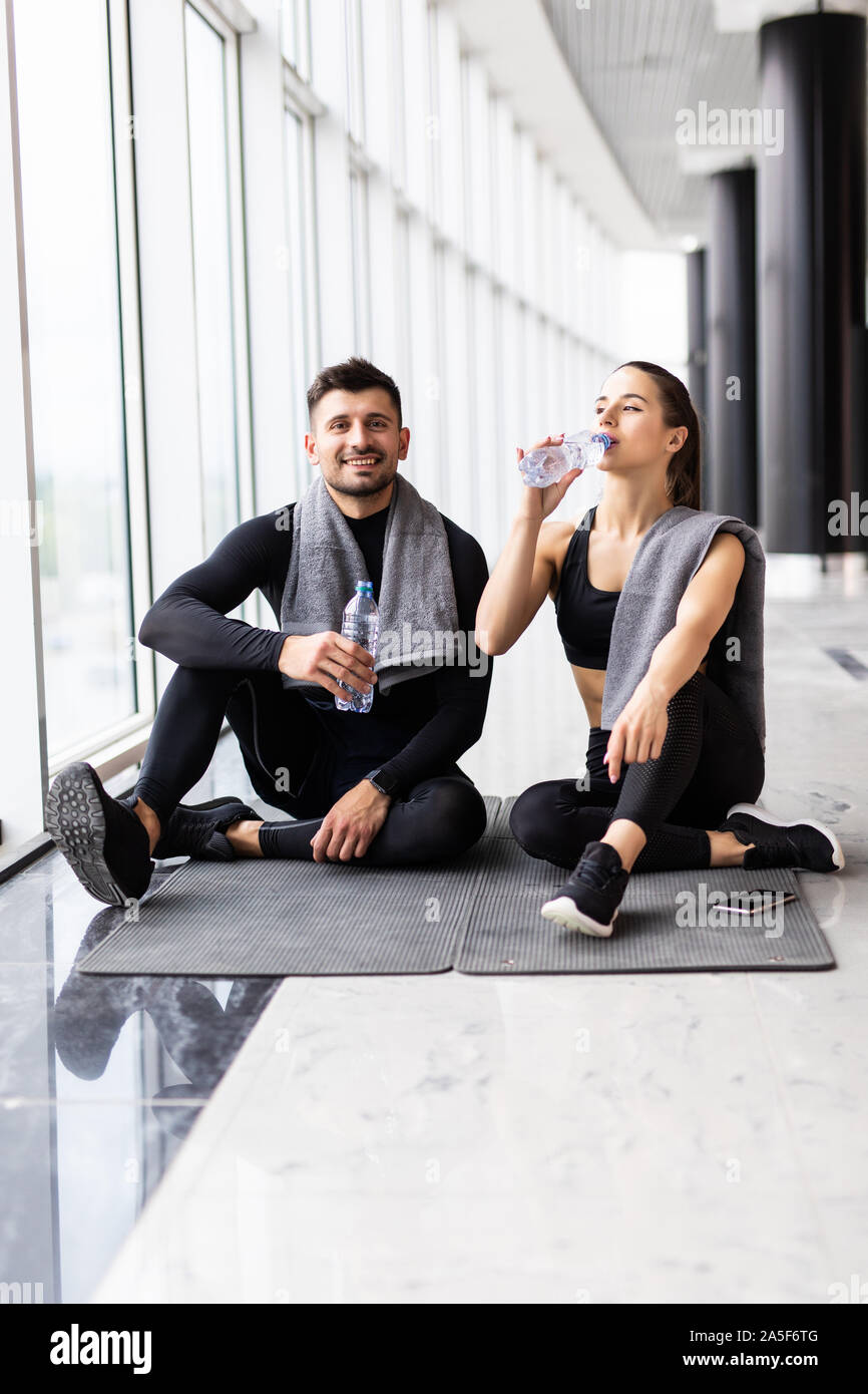 Young Healthy Couple Relaxing After Workout In the Gym with Happy ...