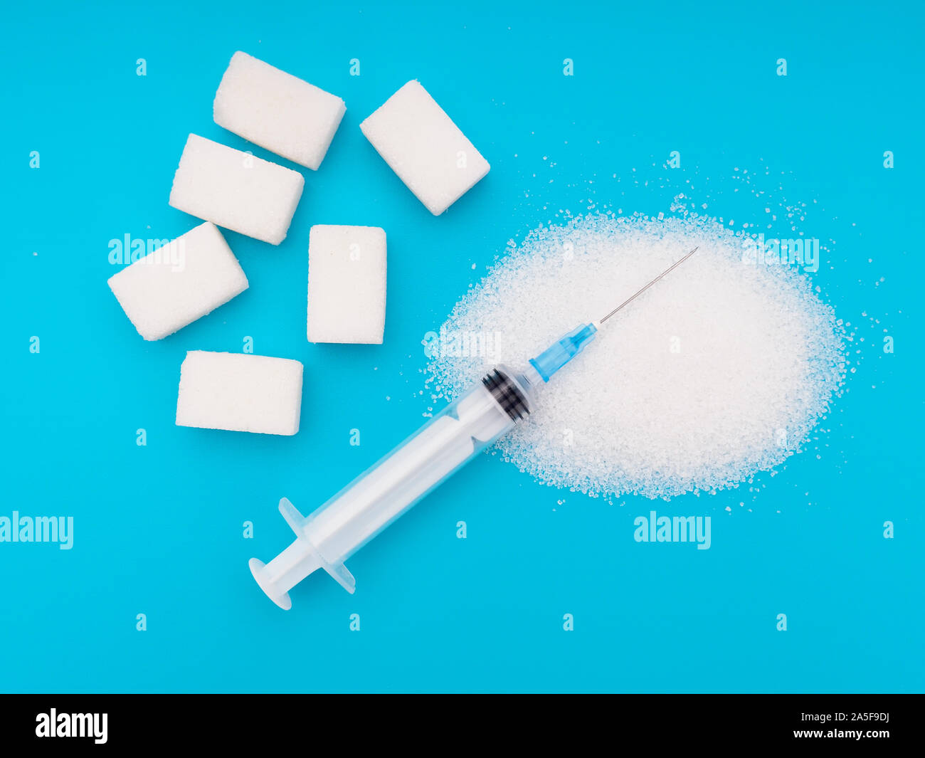White sugar, cubes and granulated, on bright colourful background with ...