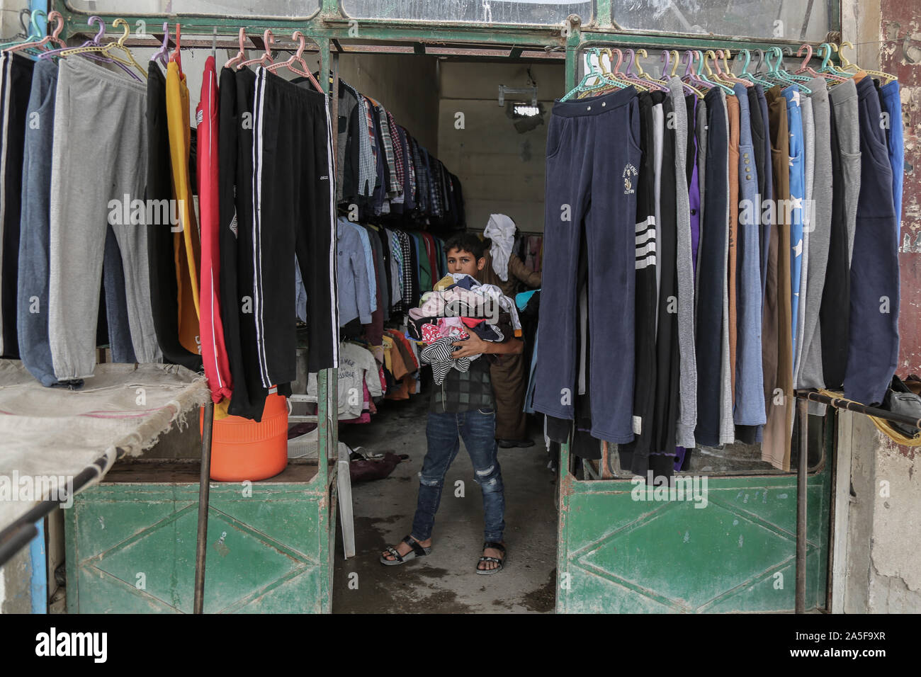 Tell Abiad, Syria. 20th Oct, 2019. A boy hold clothes inside a laundry ...