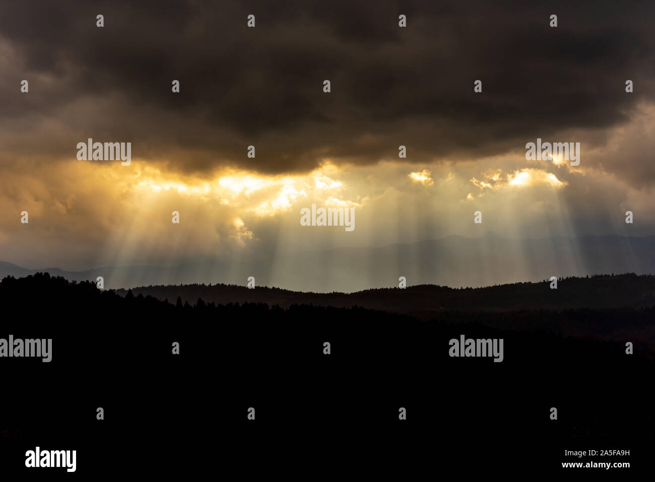 Sun rays through hole in clouds hi-res stock photography and images - Alamy