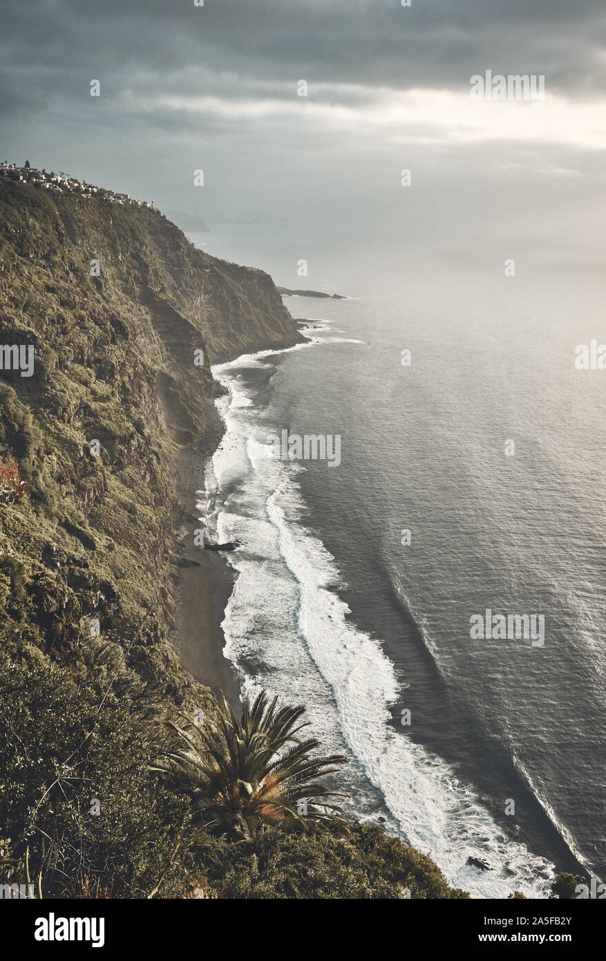 Volcanic beach seen from a cliff at sunset, color toning applied ...