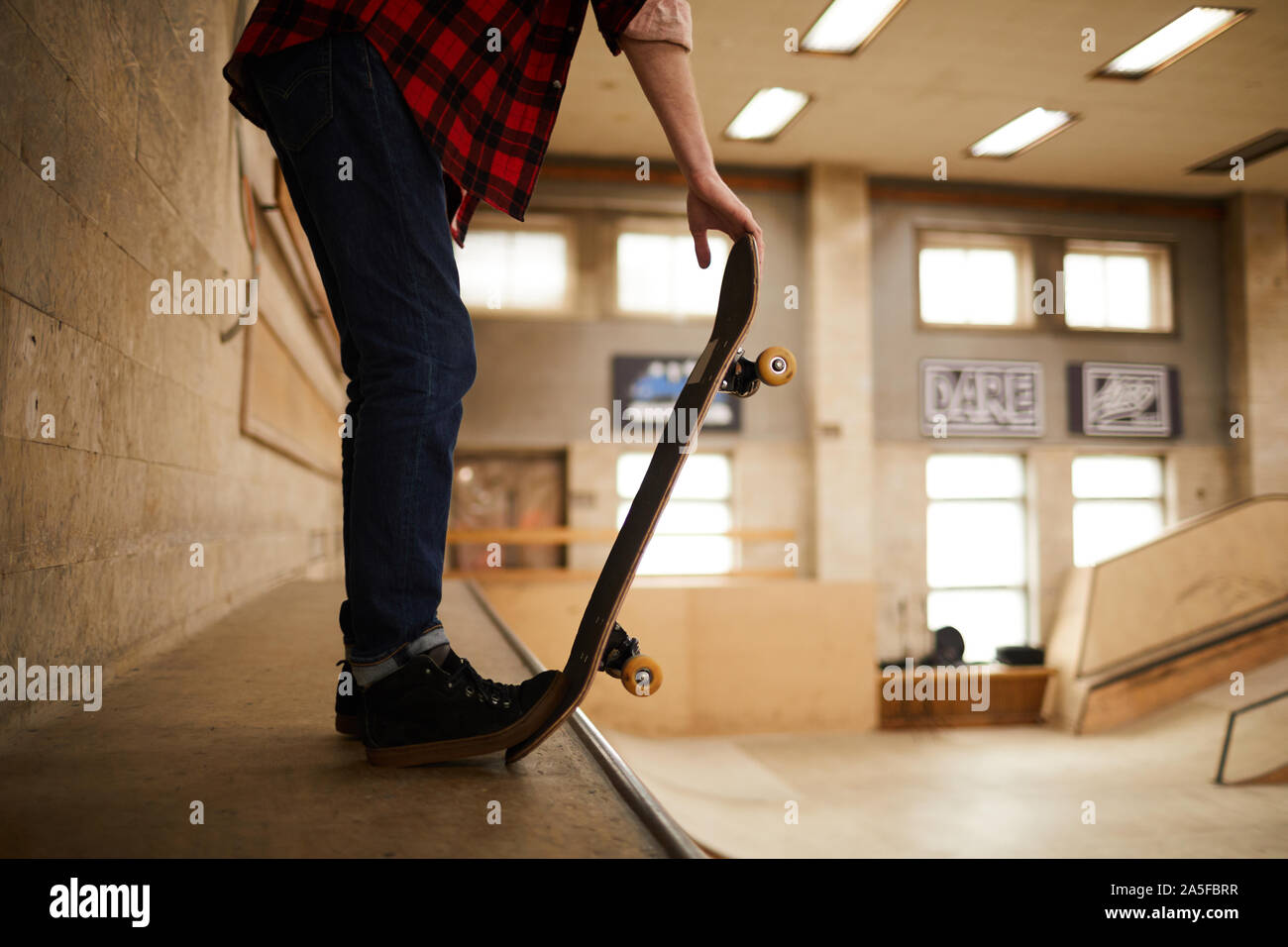 Side view of unrecognizable skater ready to do stunts and tricks on ...
