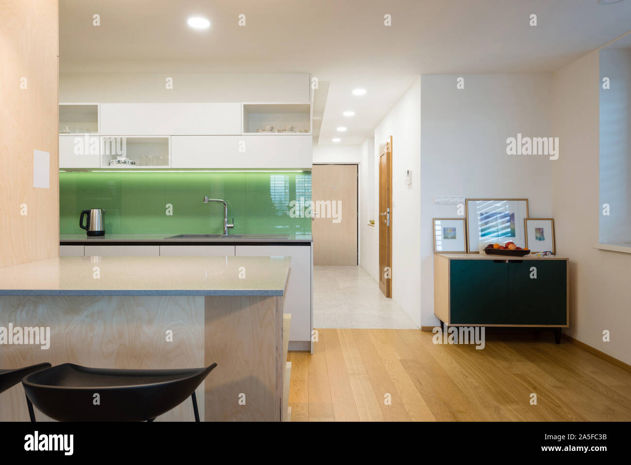 Kitchen and entrance hall in contemporary apartment Stock Photo - Alamy