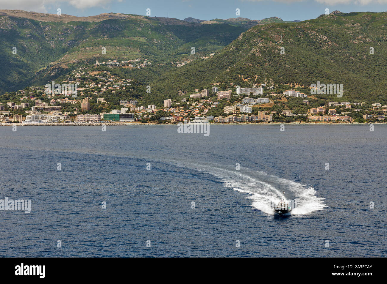 Seaside view of Corsica island, Bastia port and speed boat, France ...