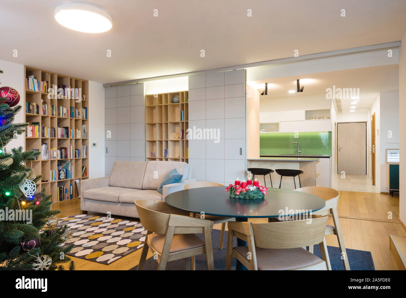 Library cabinet with sofa in contemporary living room interior Stock ...