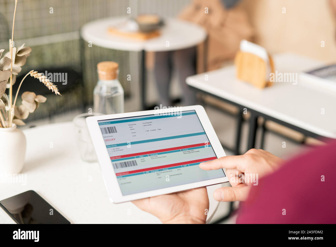 Young man pointing at display of digital tablet while scrolling through ...