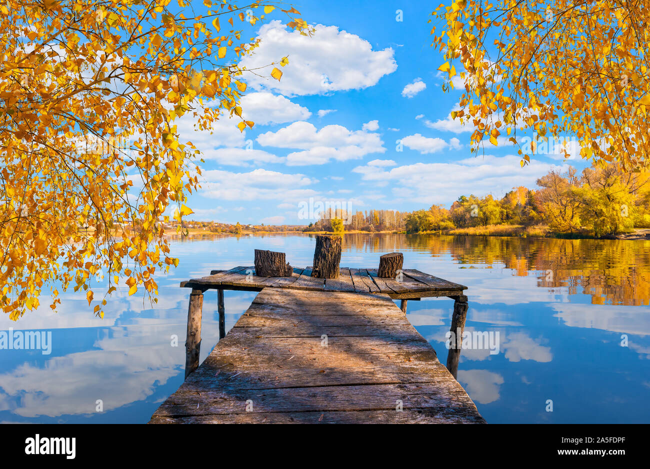 Wooden fishing pier on calm river in autumn Stock Photo - Alamy