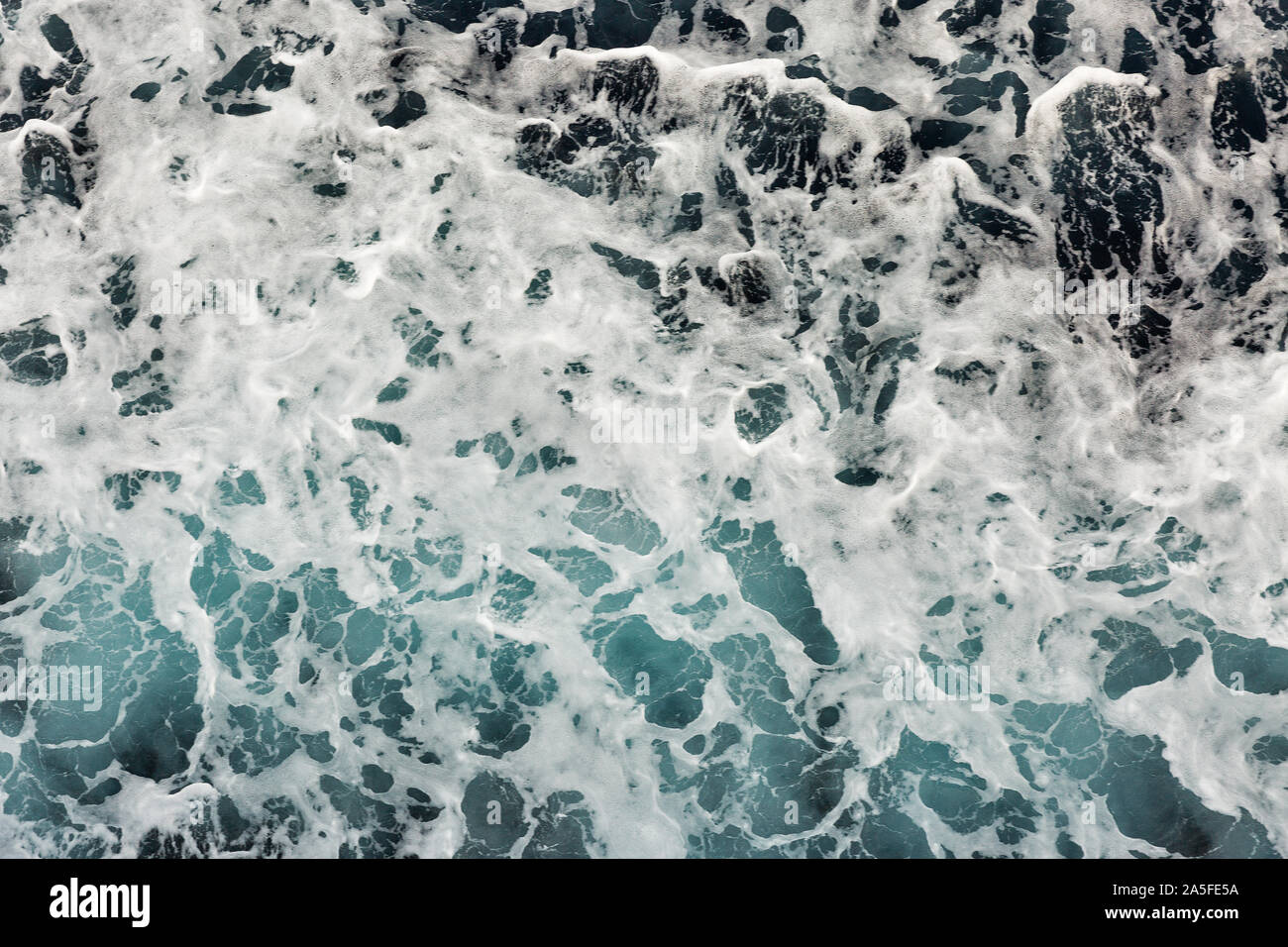 Seething surface of the deep sea with white foam background directly ...