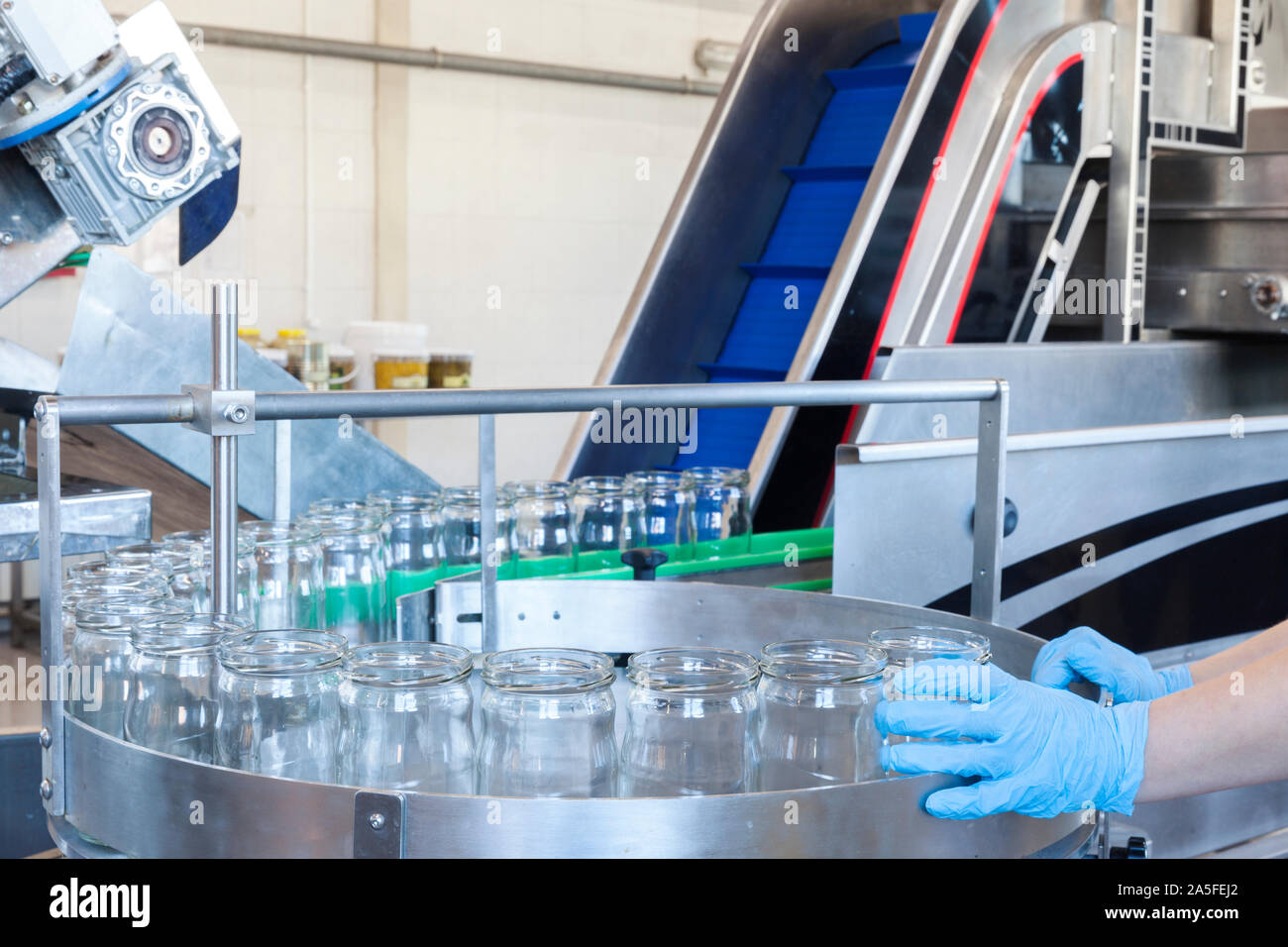 glass jars on the filling line in factory Stock Photo - Alamy