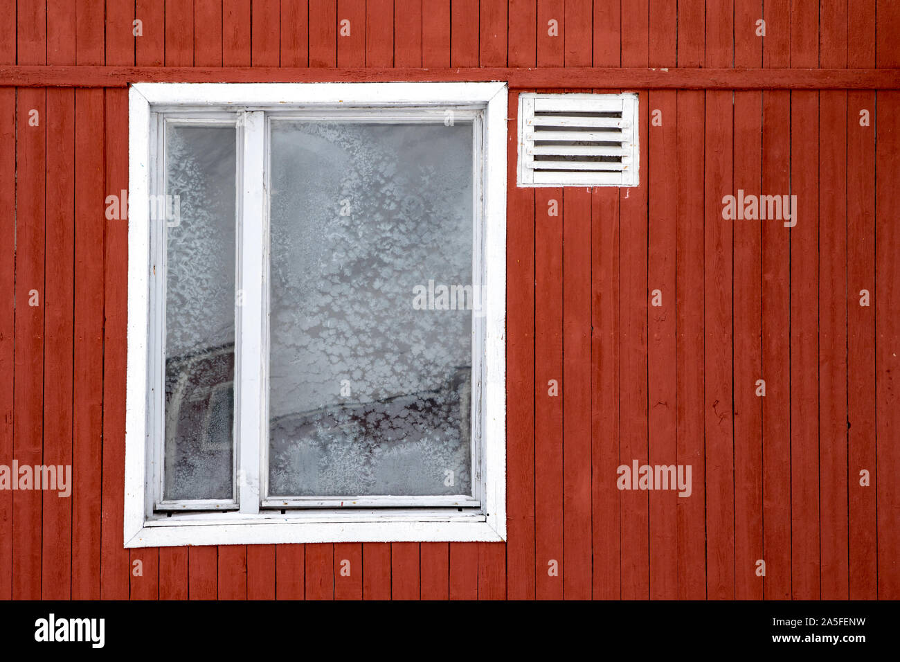 Pyramiden, Norway - August 2017: Frozen window in an old, red painted ...